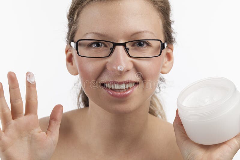 Cheerful Young Woman with a Cosmetic Product Stock Photo - Image of ...