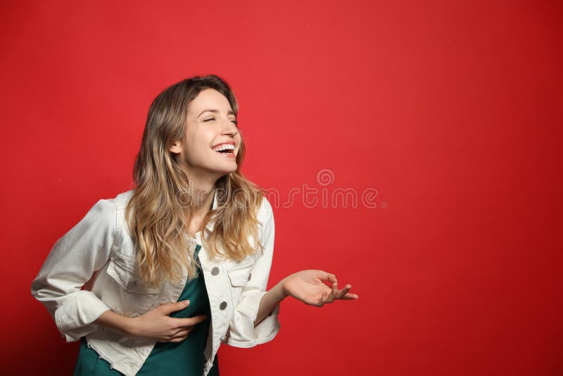 Cheerful Young Woman Laughing on Red Background. Space for Text Stock ...