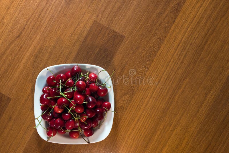 Cheery in the Plate on the Wooden Table Stock Photo - Image of bowl ...