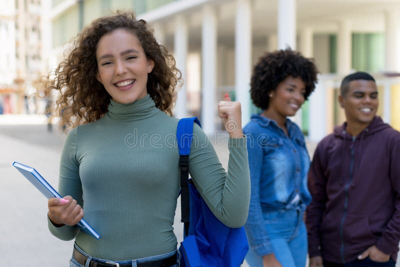 Cheering German Female Student with Backpack and Group of International ...