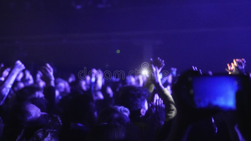 Cheering Hands at a Concert in Front of a Large Stage in the Spotlight ...