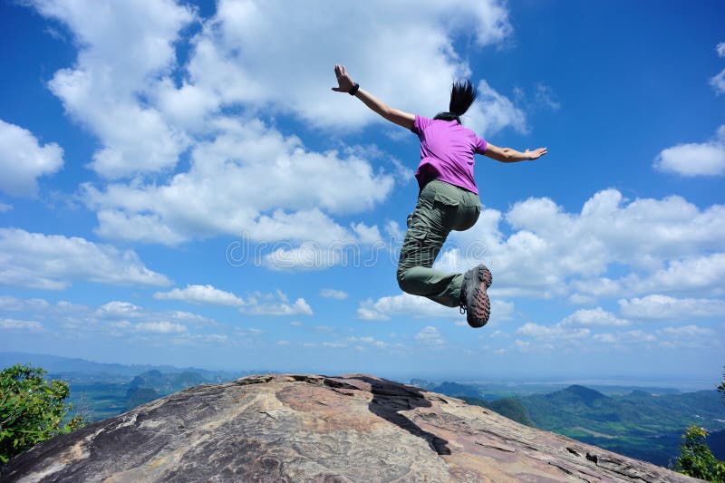 Young Woman Jumping on Mountain Peak Stock Photo - Image of excited ...