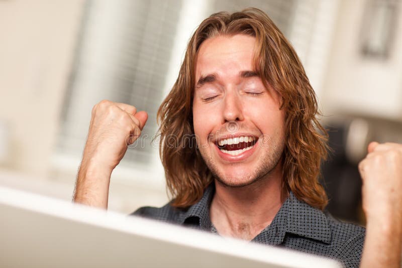 Cheering Young Man Using Laptop Computer Stock Image - Image of ...