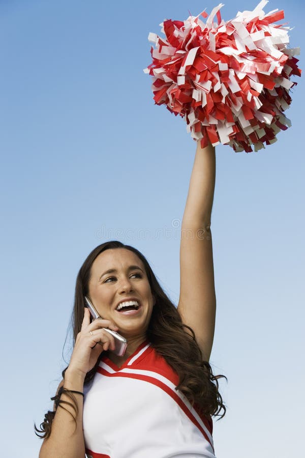 Smiling Cheerleader Sitting on Bench Stock Photo - Image of outdoors ...