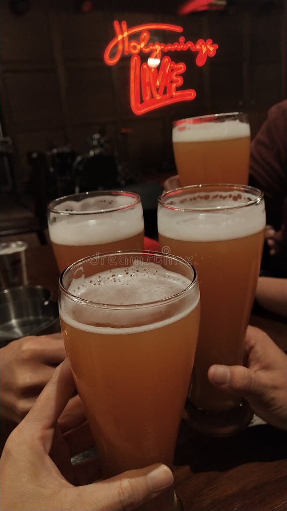 Cheers with cold beers! stock image. Image of dessert - 202071979