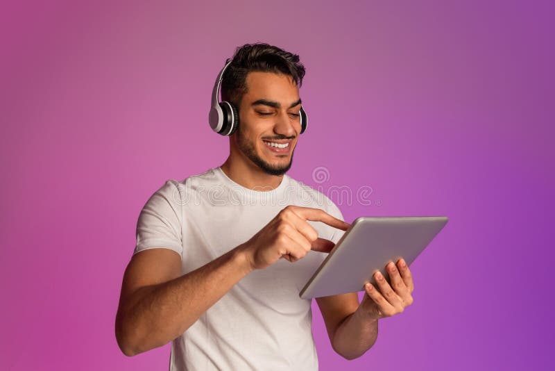 Cheery Young Arab Man Having Video Call, Using Tablet Computer, Wearing ...