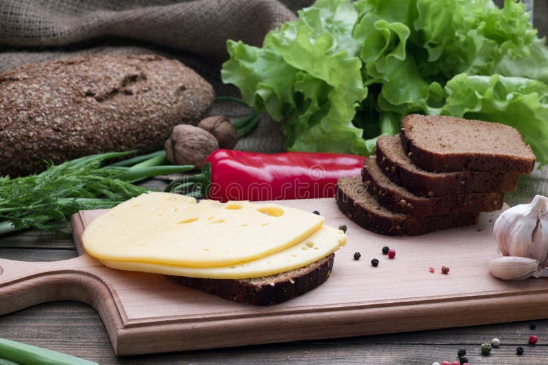 Cheese and Bread on the Table and Fresh Herbs Stock Photo - Image of ...