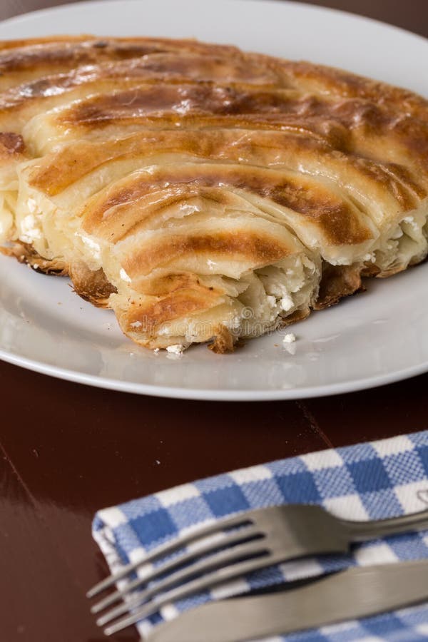 Cheese Burek Pie on the Plate with Blurred Fork and Knife Stock Image ...