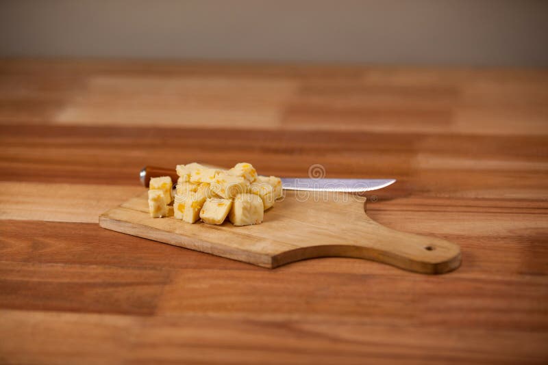 Cheese Cubes and Knife on Wooden Chopping Board Stock Image - Image of ...