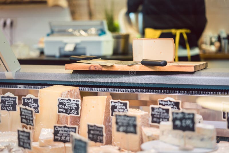 Cheese at the deli counter stock photo. Image of saleslady - 130387346