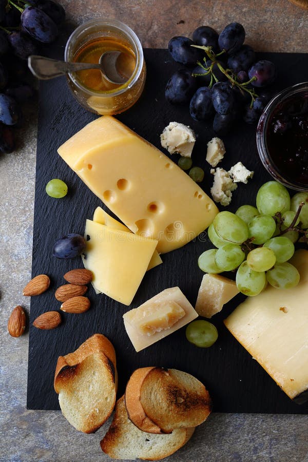 Cheese and fruits on slate stock photo. Image of honey - 61212018