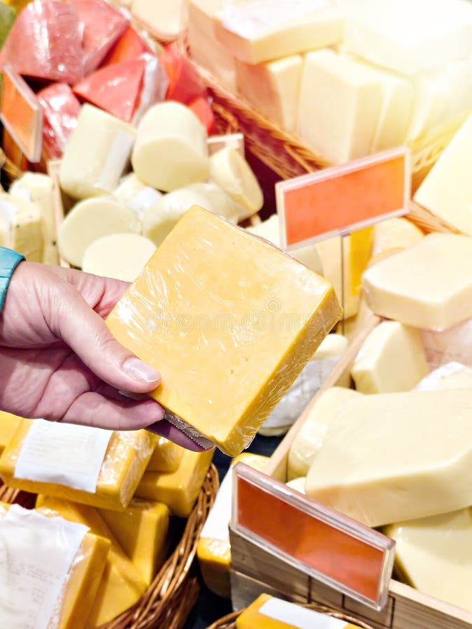 Cheese in hand stock photo. Image of sliced, market - 352200430