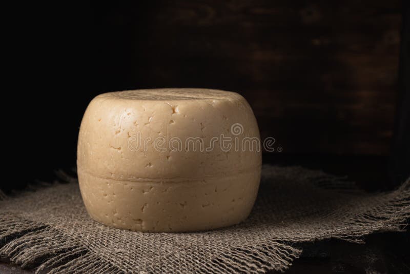 Cheese Head Lies on a Rough Burlap Lying on a Rusty Surface. Dark ...