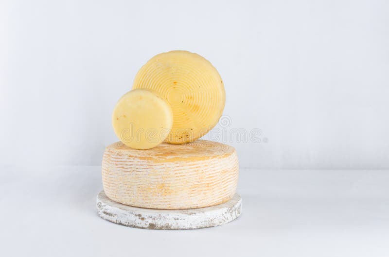 Cheese Heads of Different Kinds Stacked on Table Stock Photo - Image of ...