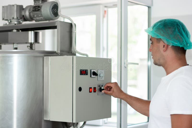 Cheese Maker Preparing the Machine for the Cheese-making Process. Stock ...