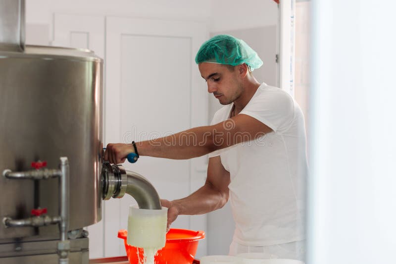 Cheese Maker Preparing the Machine for the Cheese-making Process. Stock ...
