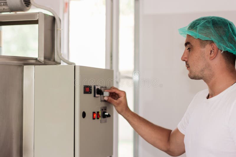Cheese Maker Preparing the Machine for the Cheese-making Process. Stock ...