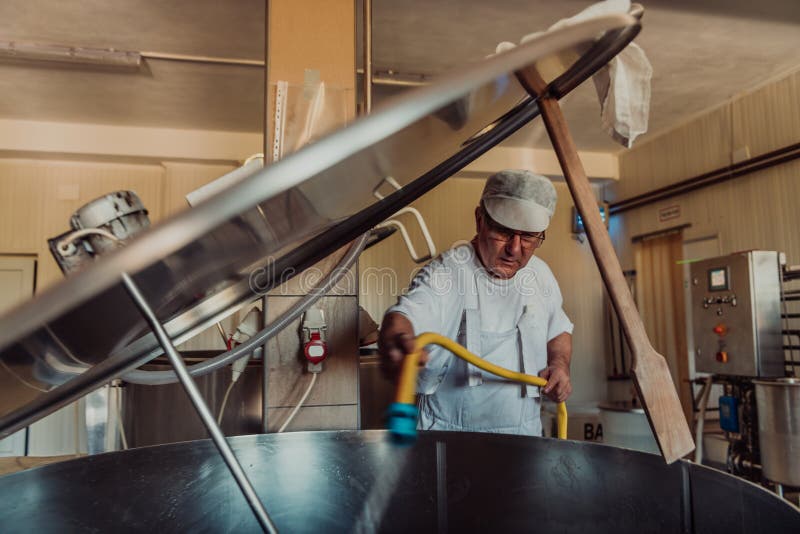 A Cheese Makser Working in the Industry on Various Machines with the ...