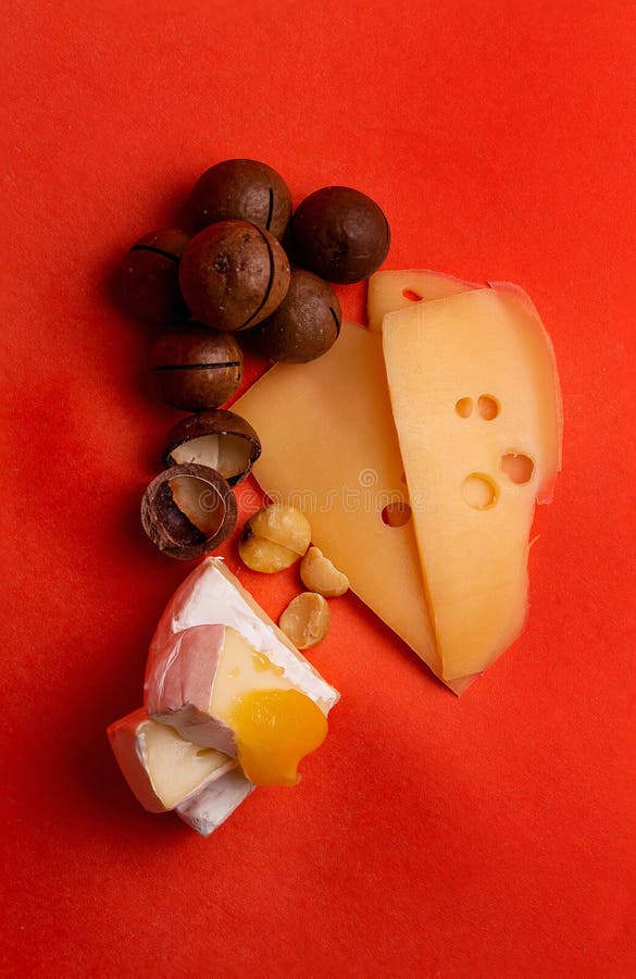 Cheese and Nuts on a Red Background Top View Stock Image - Image of ...