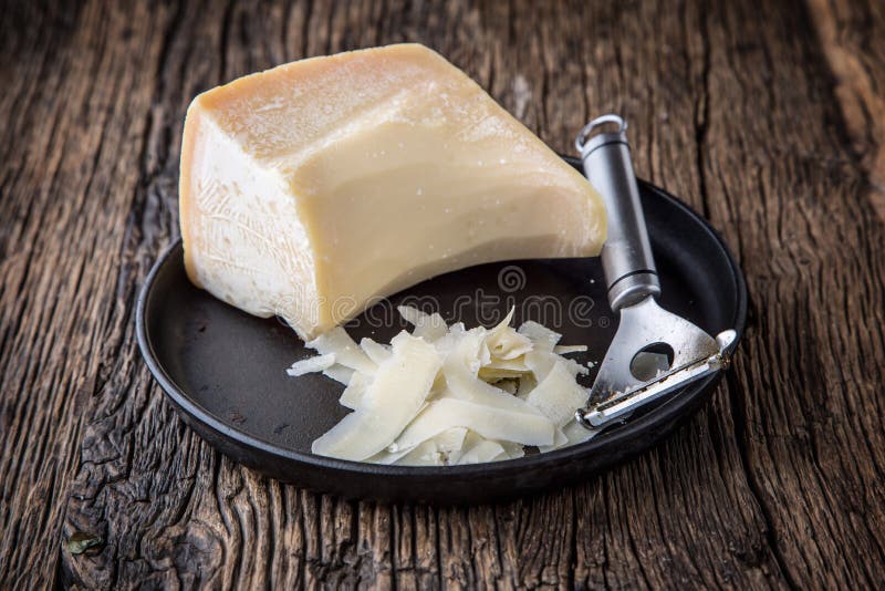 Cheese Parmesan . Parmesan Cheese on Old Oak Table with Cheese Grater ...