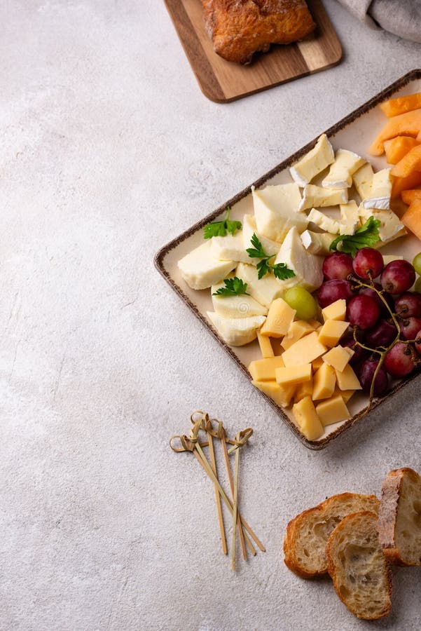 Cheese Plate with Different Cheese, Grapes and Melon. Stock Image ...