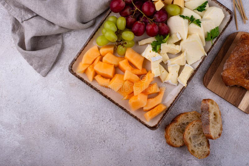 Cheese Plate with Different Cheese, Grapes and Melon. Stock Image ...