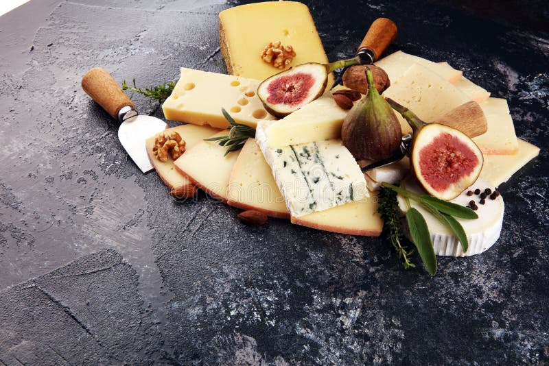 Cheese Plate Served with Figs, Various Cheese on a Rustic Table Stock ...