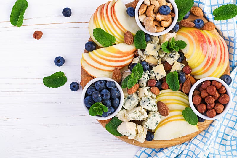 Cheese Platter with Assorted Cheeses, Blueberry, Apples, Nuts on White ...