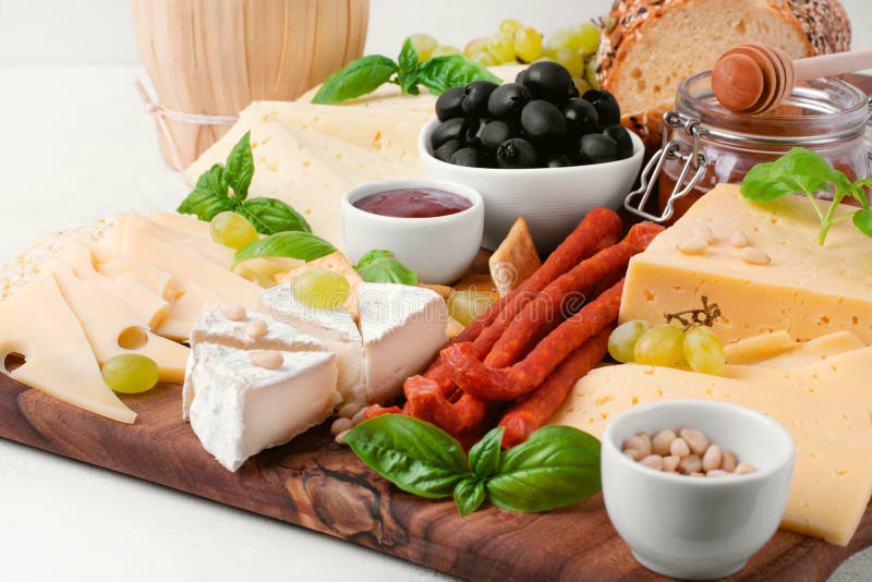 Cheese Platter with Assorted Cheese, Sausage, Jam, Olives and Grapes ...
