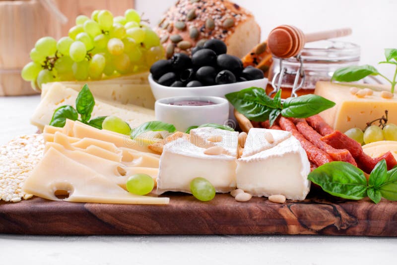 Cheese Platter with Assorted Cheese, Sausage, Jam, Olives and Grapes ...