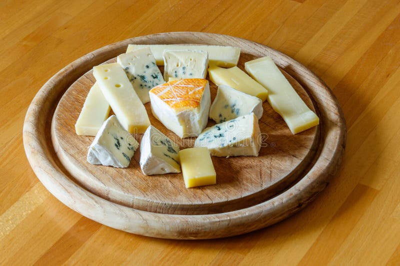Cheese Platter with Different Kinds of Cheese on Wooden Table Stock ...