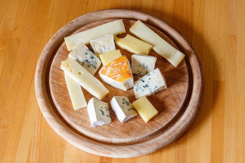 Cheese Platter with Different Kinds of Cheese on Wooden Table Stock ...