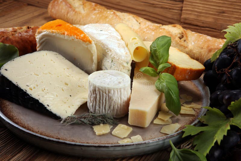 Cheese Platter with Different Cheese on Rustic Plate Stock Photo ...