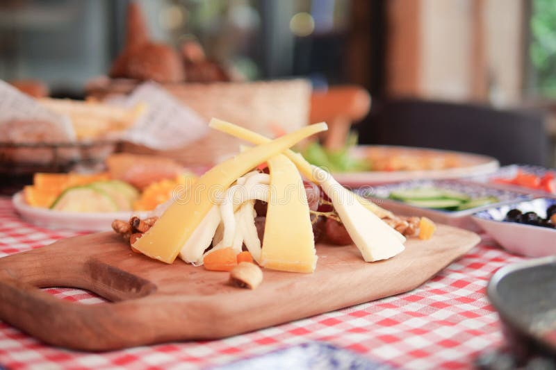 Cheese Platter Displays Variety of Cheeses and Snacks in Cozy Setting ...