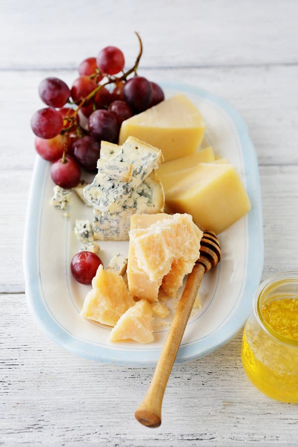 Cheese platter with grapes stock photo. Image of board - 65751678
