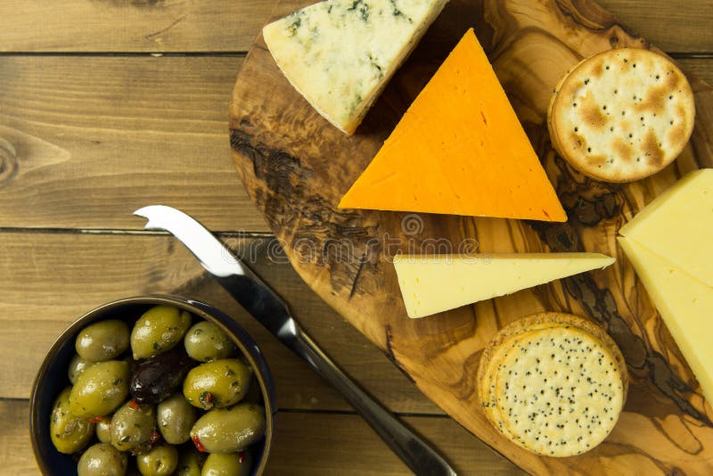 Cheese Platter with Olives and Biscuits on Wood Table Stock Photo ...