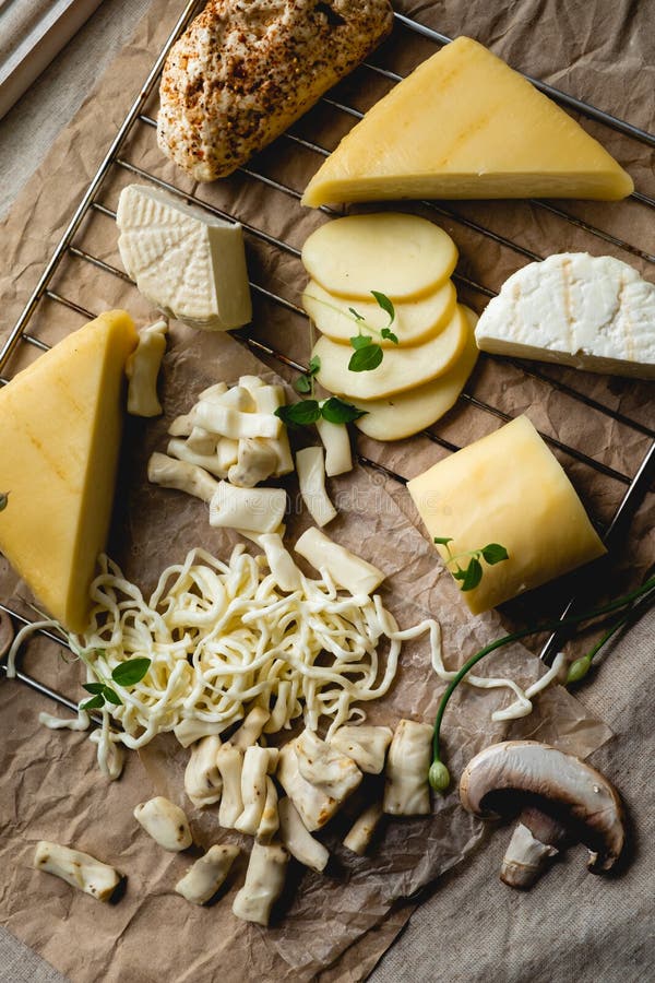 Cheese Platter in a Rustic Interior with Herbs and Mushrooms. Home ...