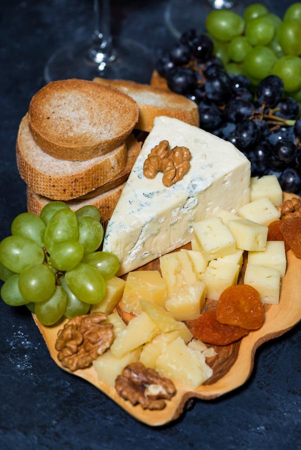 Cheese Platter on a Wooden Board, Bread and Fruit, Vertical Stock Photo ...