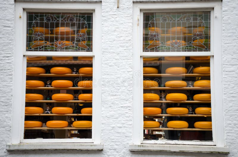 Cheese for Sale Behind Two Windows Stock Image - Image of pile ...