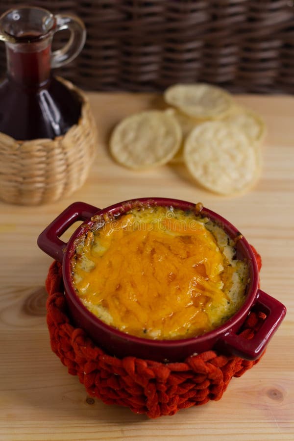 Cheese Sauce in a Red Saucepan, Next To Chips and a Bottle of Red Juice ...