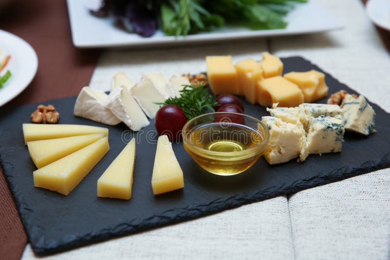 Dish with Different Cheeses on a Black Rug Stock Photo - Image of black ...