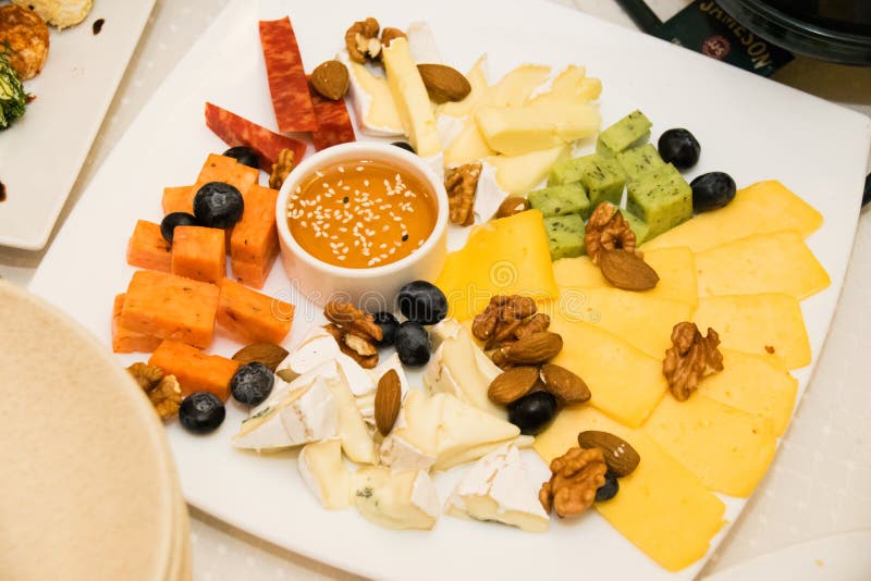 Cheese Slices from Different Cheeses on a Plate. Appetizer To Wine on ...