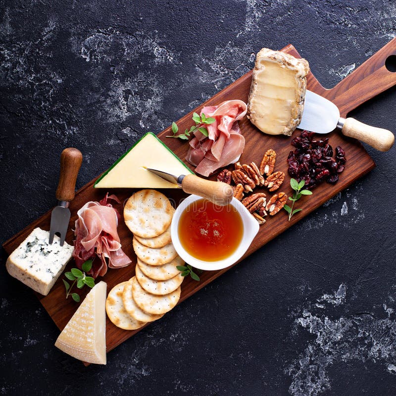 Cheese and snack board stock photo. Image of plank, delicatessen ...