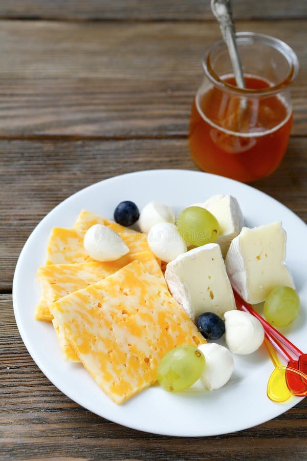 Cheese snack on a plate stock photo. Image of cheeseboard - 44887138
