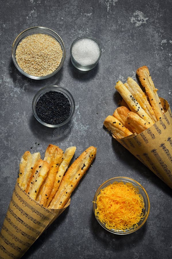 Cheese Straws and Sesame Seeds in a Paper Cone Stock Image - Image of ...