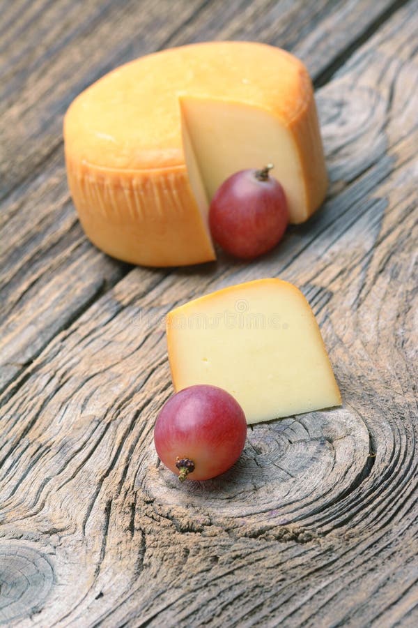 Cheese Wheel on Wooden Table. Stock Image - Image of cellar, cheddar ...