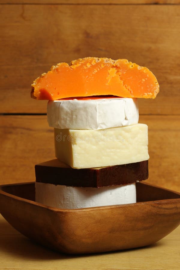 Cheese in wooden bowl stock image. Image of diversity - 13020961