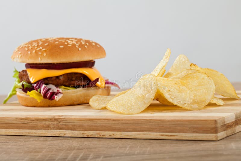 Cheeseburger with chips stock image. Image of homemade - 143248525