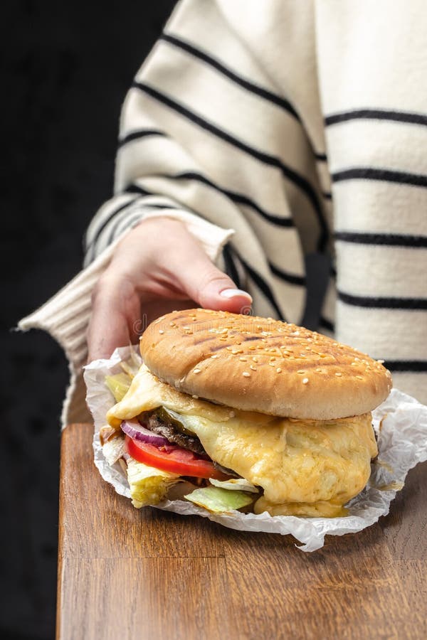 Cheeseburger. Melted Cheese Burger in Hand. Fast Food Take Away Stock ...