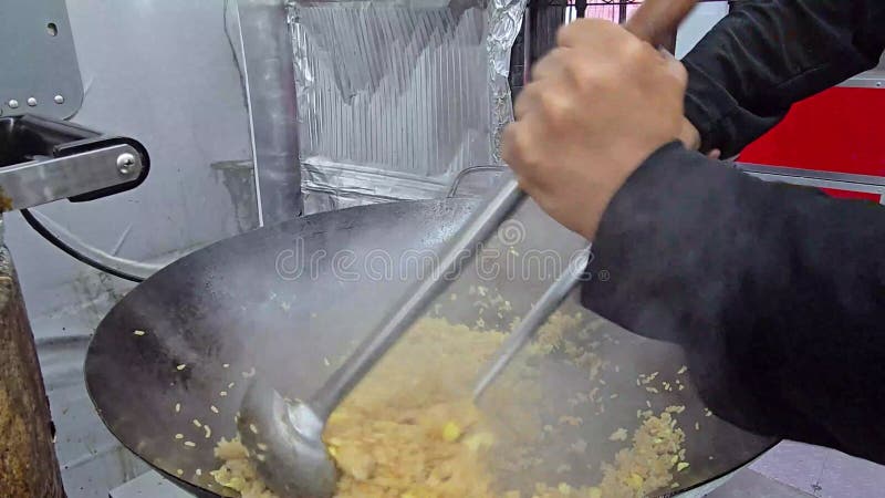 Chef Actively Stirring Fried Rice in a Large Wok, Showcasing ...